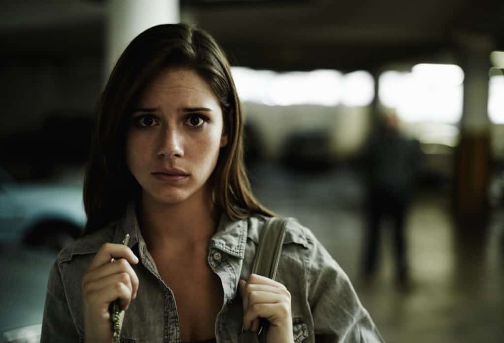 worried woman with stranger behind her | Not The Victim